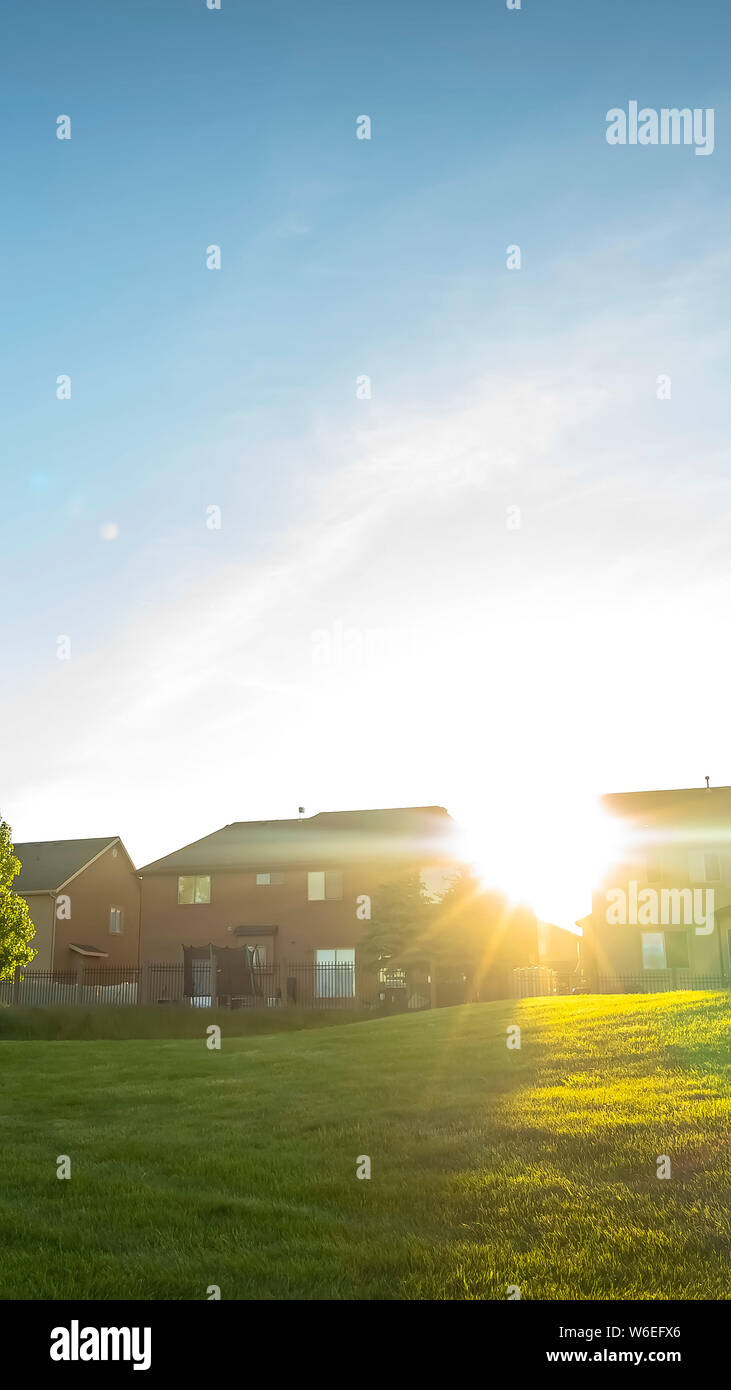 Vertical Sun in the vast blue sky shining brightly over beautiful multi ...