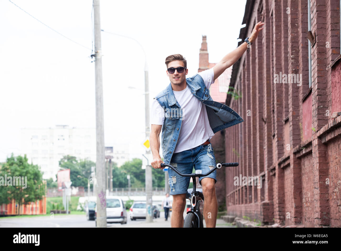 Handsome hipster enjoying city ride by bicycle Stock Photo - Alamy