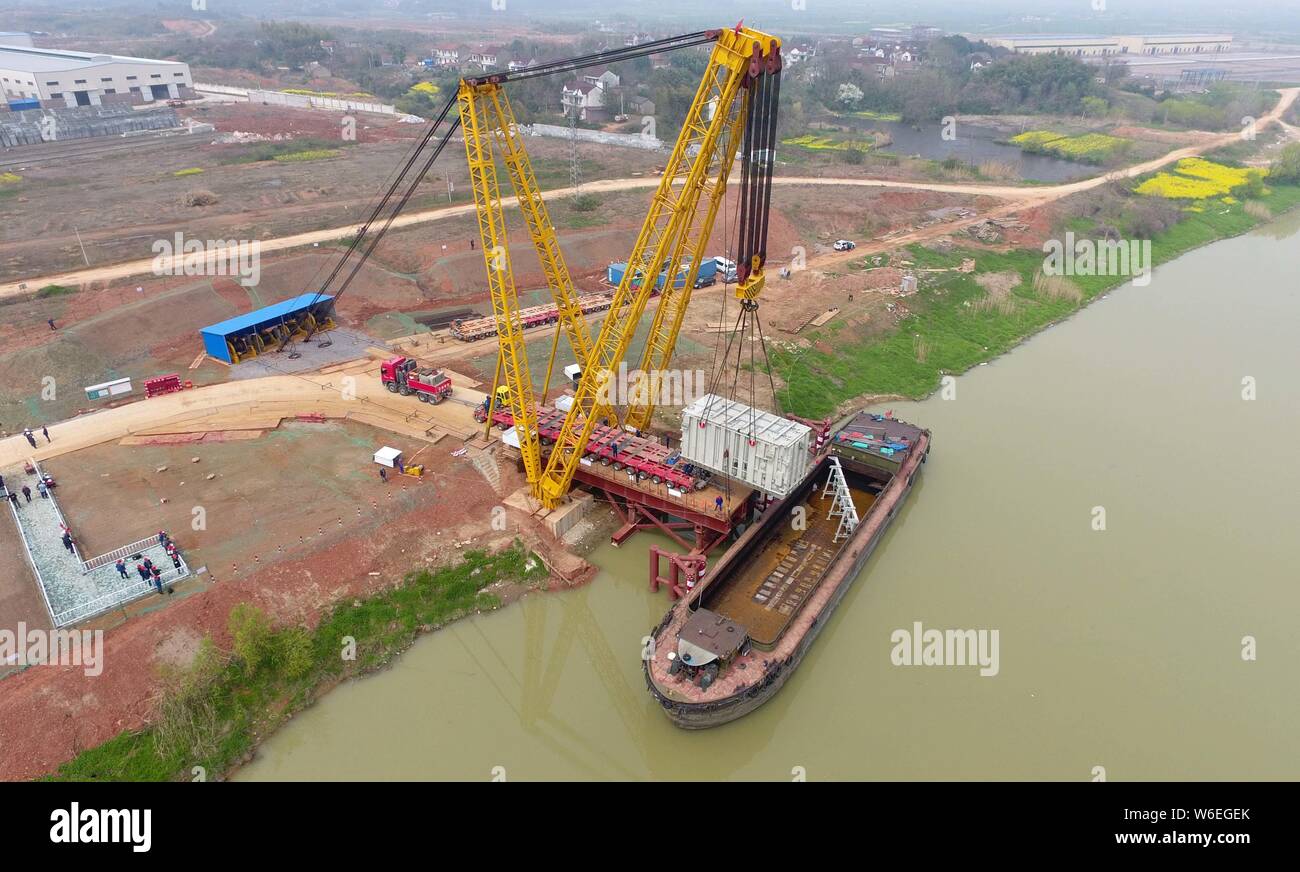 A crane vehicle lifts the world's most powerful converter transformer ...