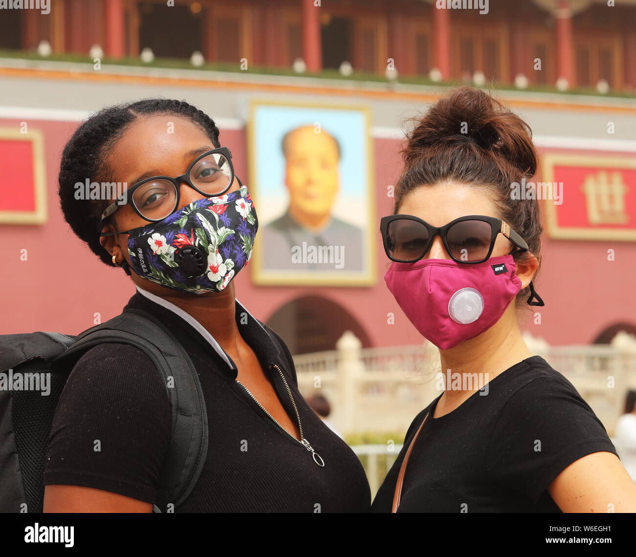 Foreign tourists wearing face masks against air pollution visit the ...