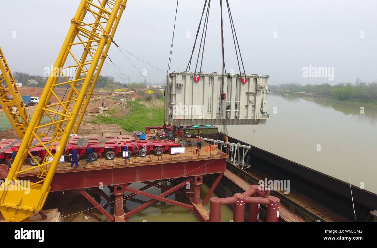 A crane vehicle lifts the world's most powerful converter transformer ...