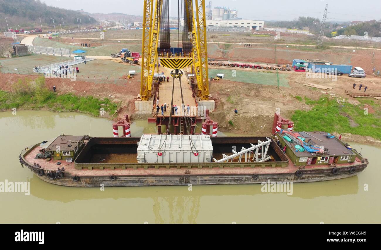 A crane vehicle lifts the world's most powerful converter transformer ...