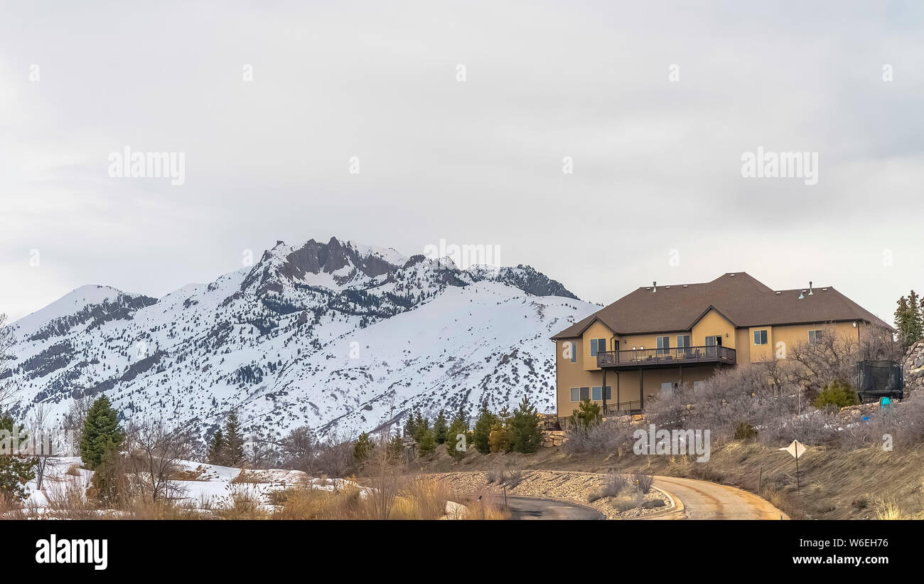 Panorama frame Homes and road on a hill with an overcast sky overhead ...