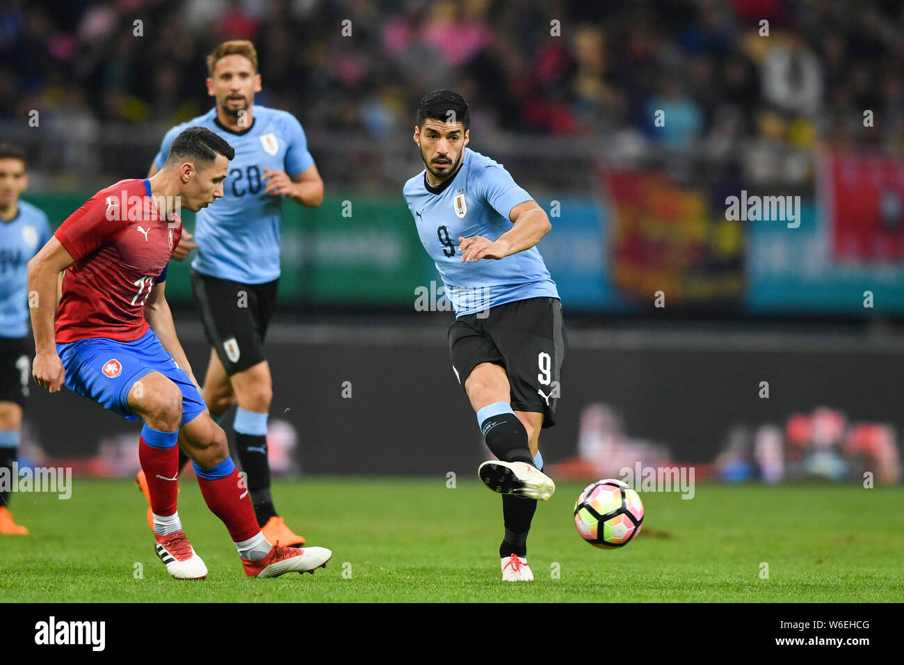 Luis Suarez, right, of Uruguay national football team kicks the ball to ...