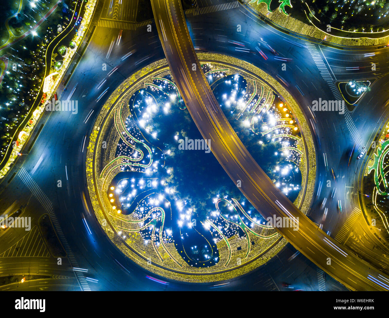 Aerial night view of a roundabout and the nearby roads, resembling the ...