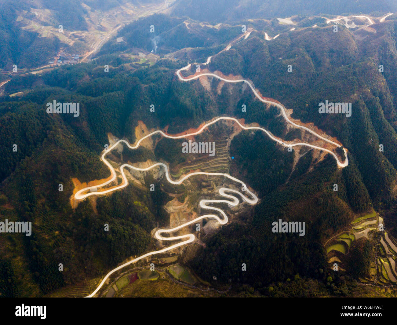 Aerial view of a winding highway around a mountain in Congjiang county ...