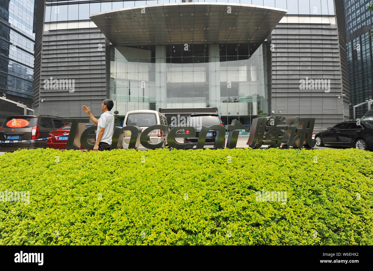 --FILE--A pedestrian walks past the headquarters building of Tencent in ...