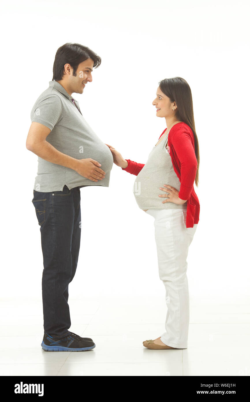 Man imitating his pregnant wife Stock Photo - Alamy