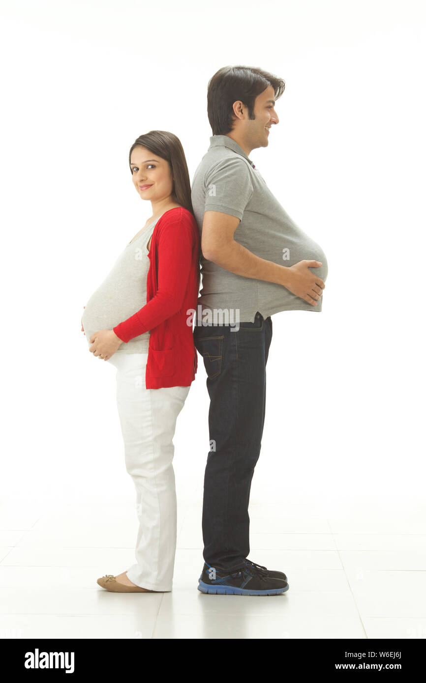Man imitating his pregnant wife Stock Photo - Alamy