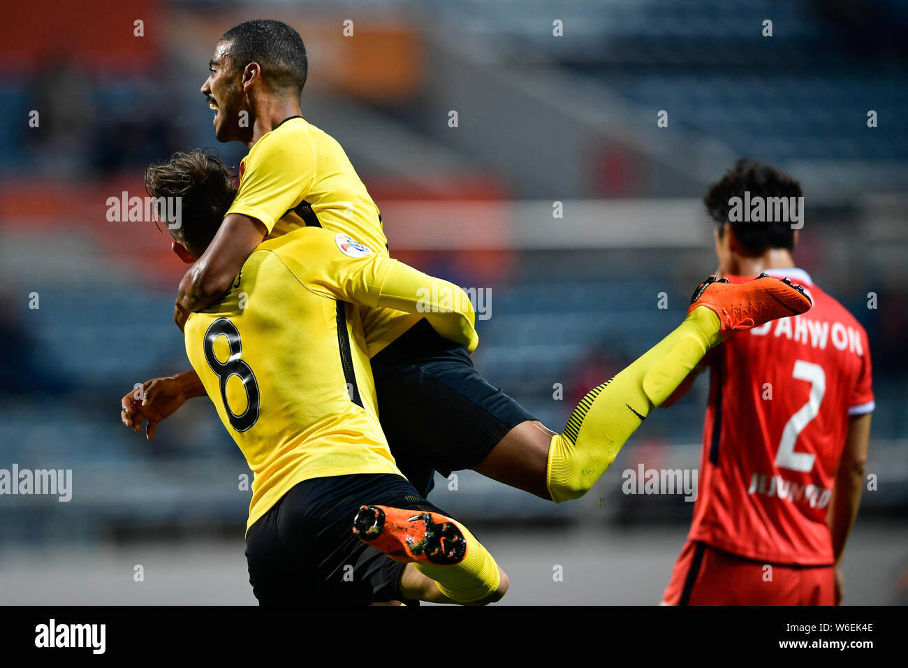 Brazilian football player Alan Carvalho, center, of China's Guangzhou ...