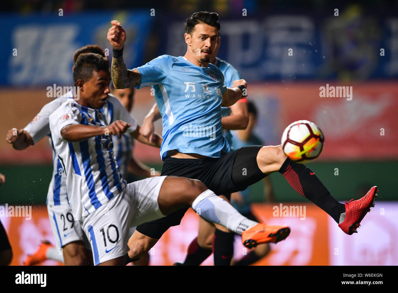 Argentinian football player Jonathan Ferrari, right, of Dalian Yifang ...