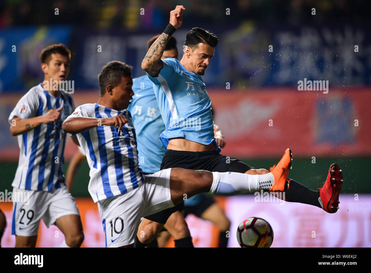 Argentinian football player Jonathan Ferrari, right, of Dalian Yifang ...