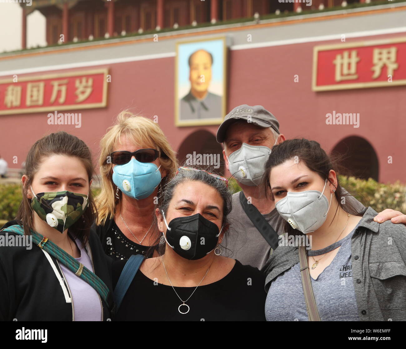 Foreign tourists wearing face masks against air pollution visit the ...