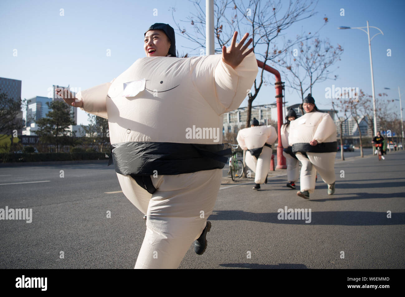 Chinese women dressed in inflatable sumo-wrestler costumes take part in ...