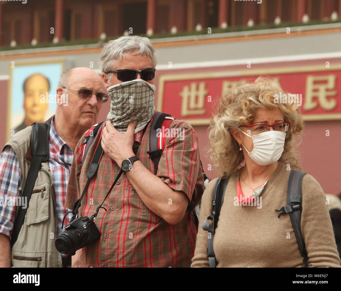 Foreign tourists wearing face masks against air pollution visit the ...