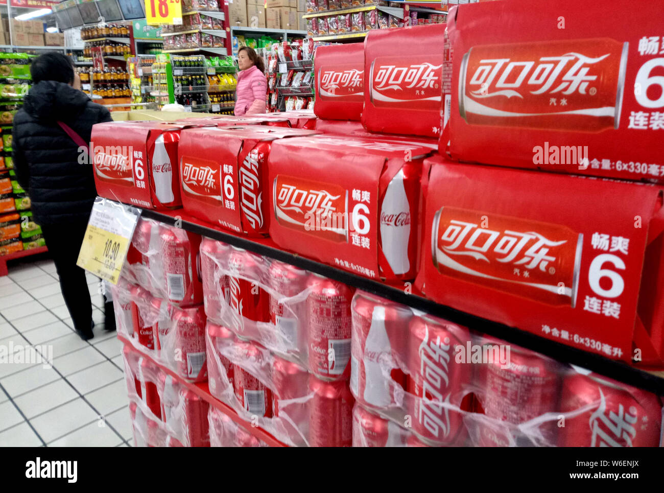 --FILE--Tins of Coca-Cola coke are seen for sale at a supermarket in ...