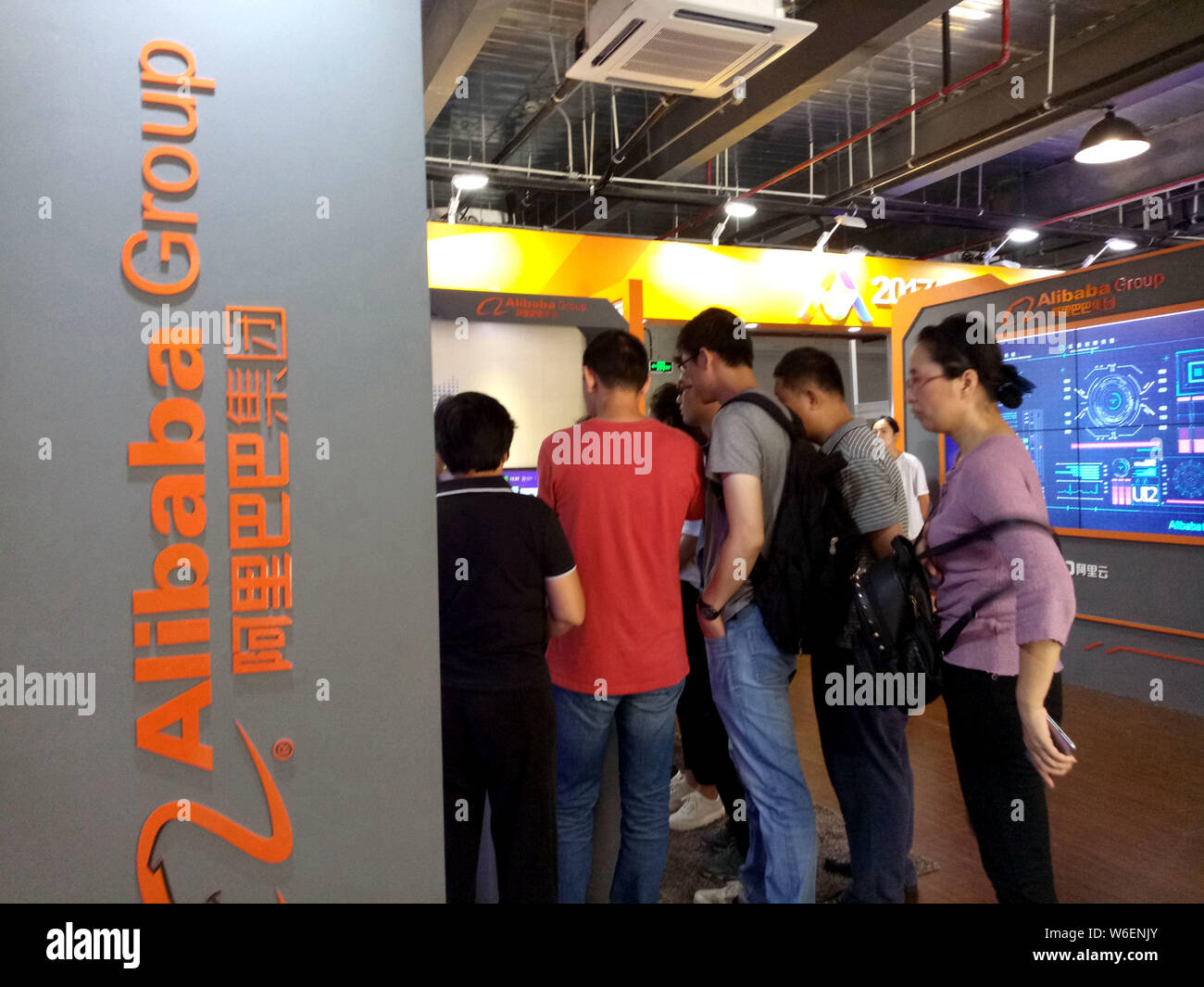 --FILE--People visit the stand of Alibaba group during an exhibition in ...