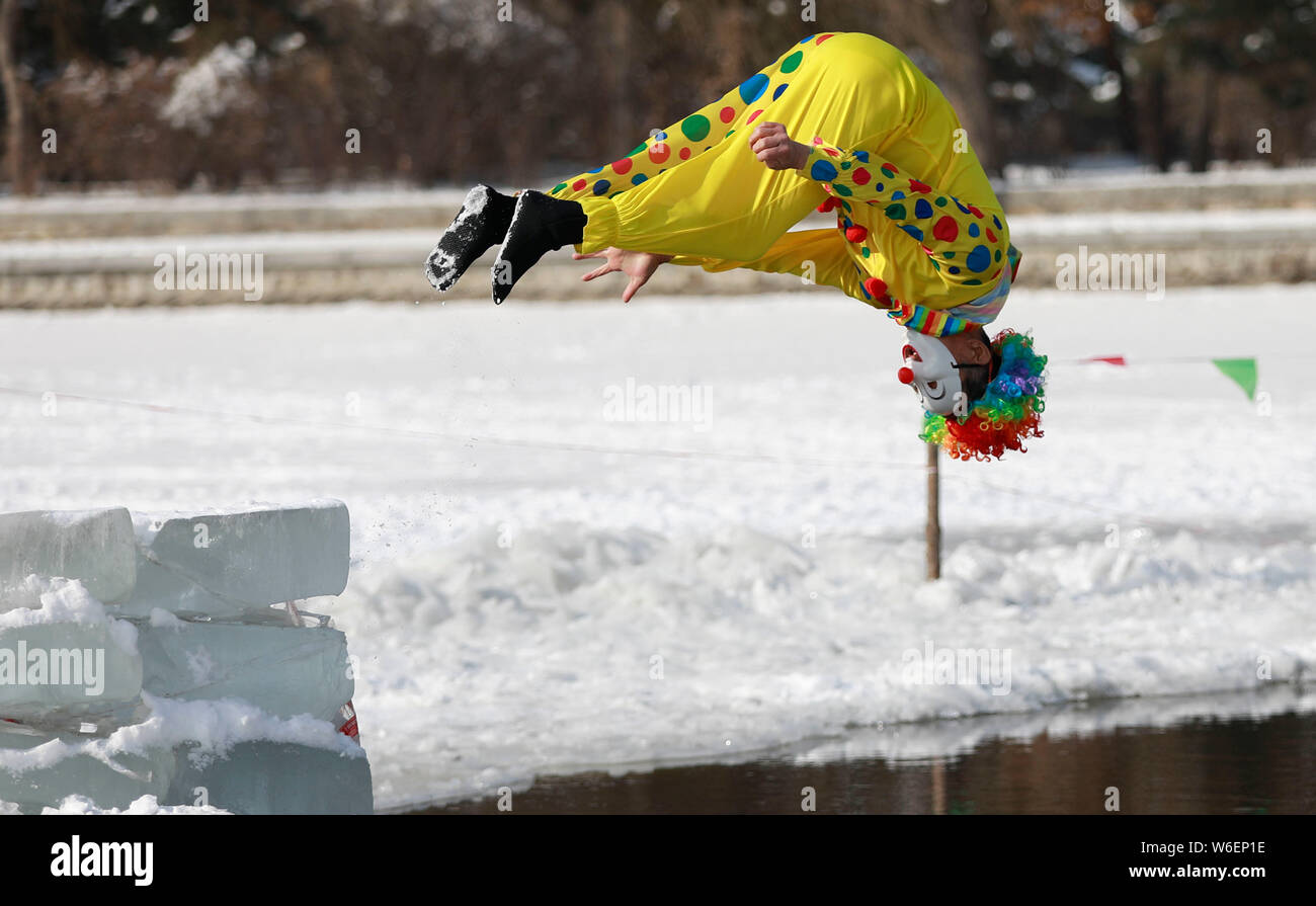 A Chinese winter swimming enthusiast dressed in the clown costume ...