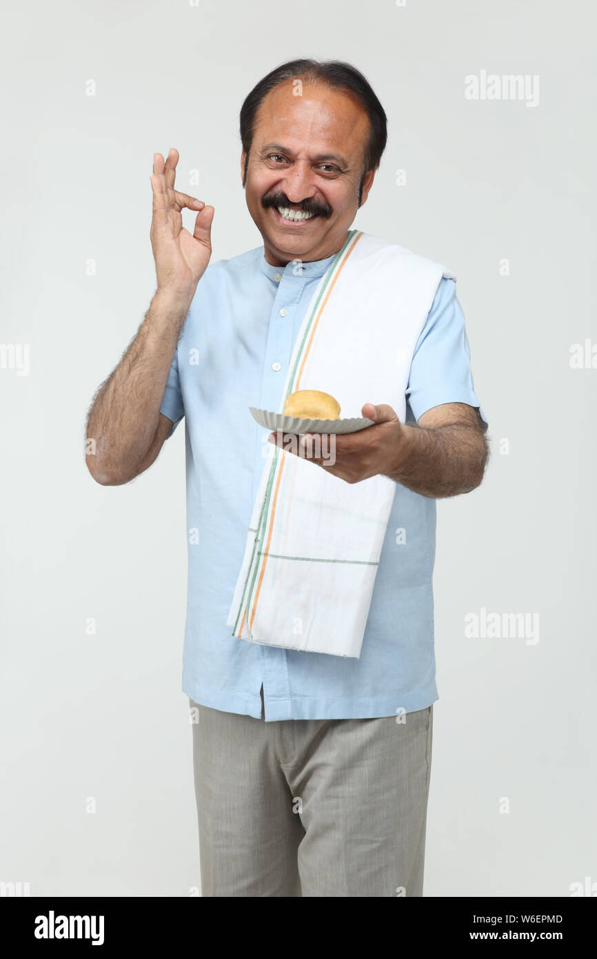 Portrait of a south Indian man holding a plate of paneer pakora Stock ...