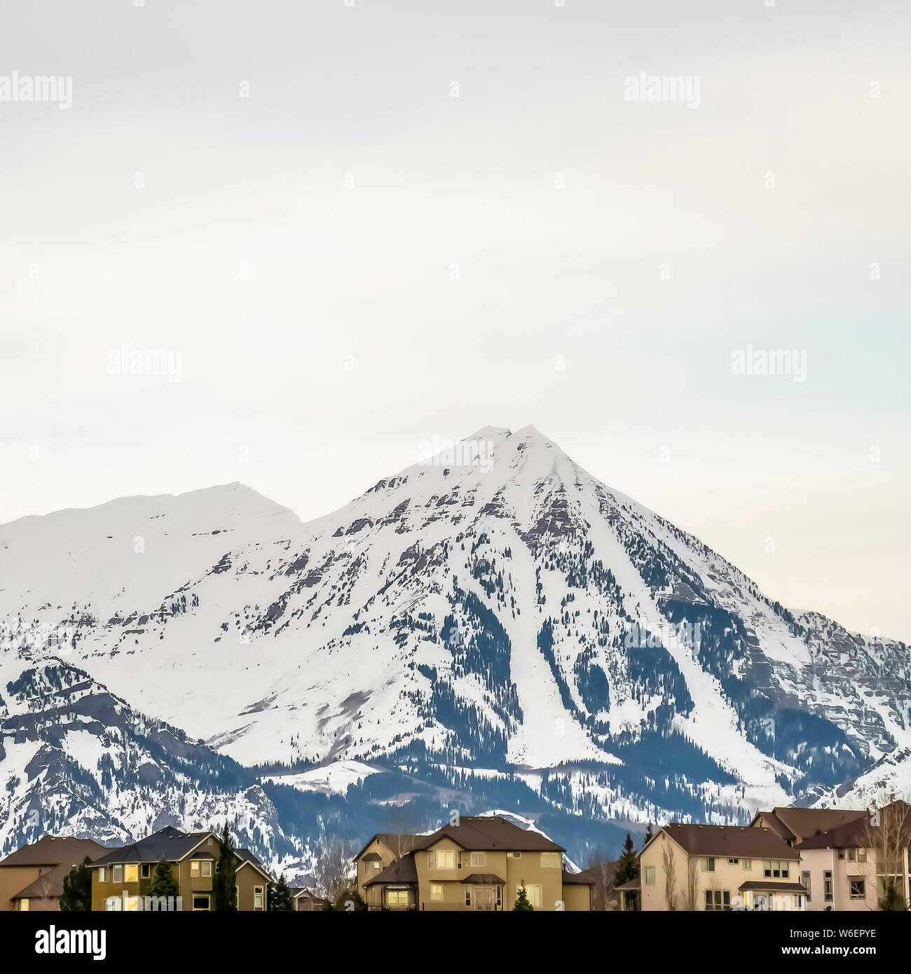 Square frame Homes built on a hill with view of striking mountain ...