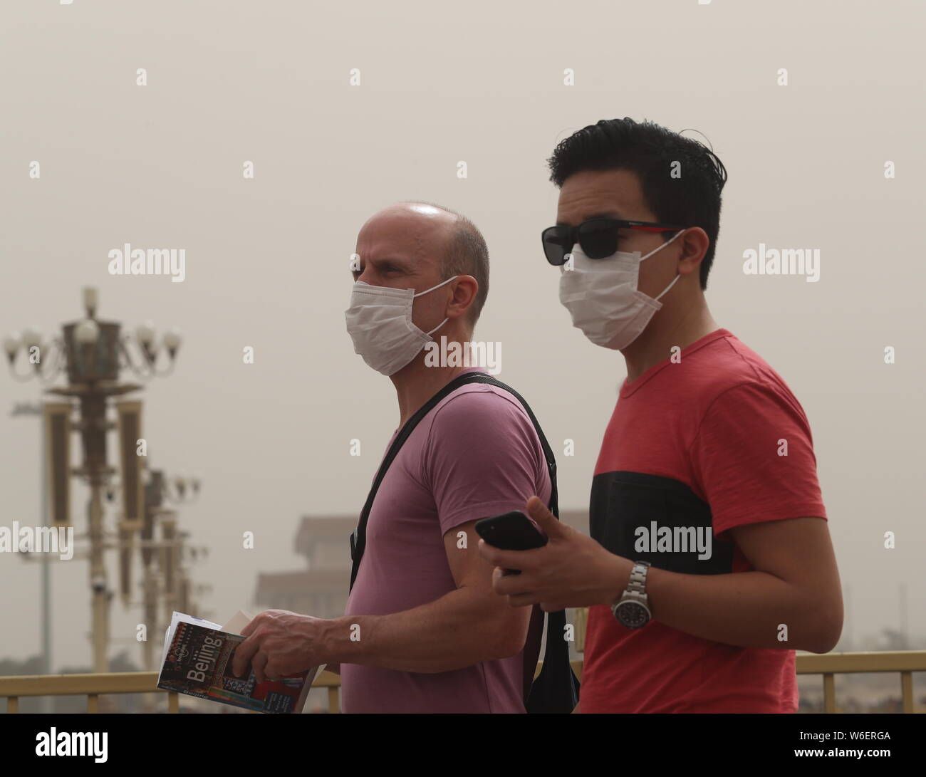 Foreign tourists wearing face masks against air pollution visit the ...