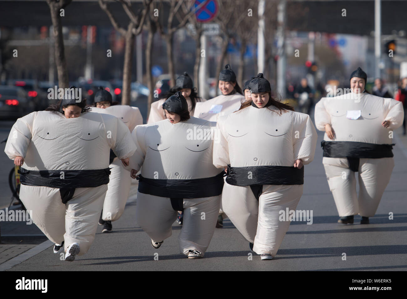 Chinese women dressed in inflatable sumo-wrestler costumes take part in ...