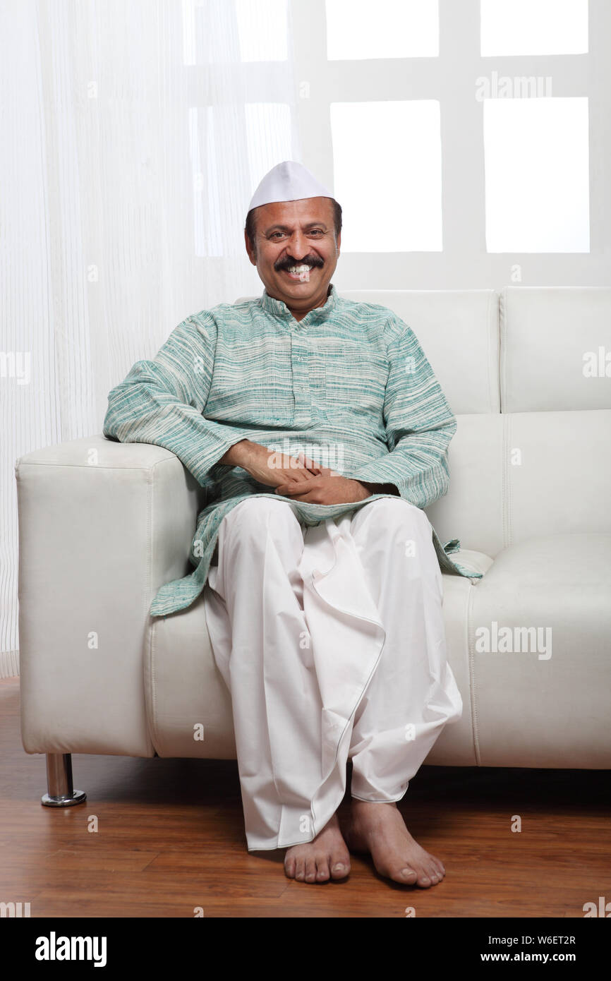 Politician sitting on couch and smiling Stock Photo - Alamy