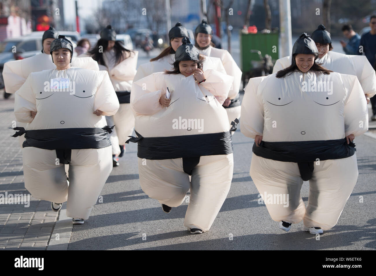 Chinese women dressed in inflatable sumo-wrestler costumes take part in ...