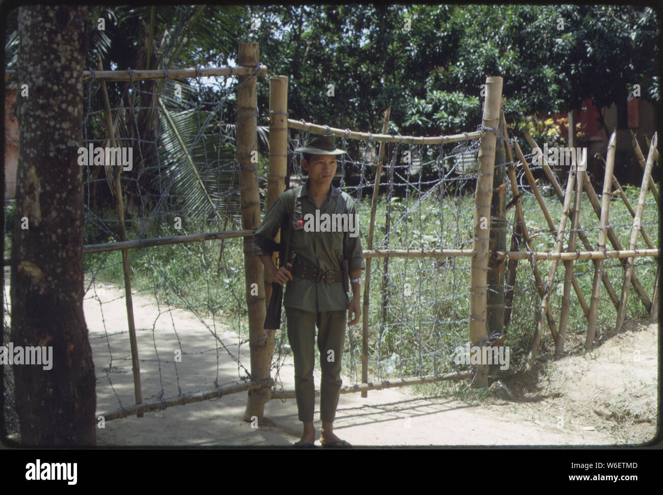 A young soldier from the Popular Forces stands gate guard duty in ...