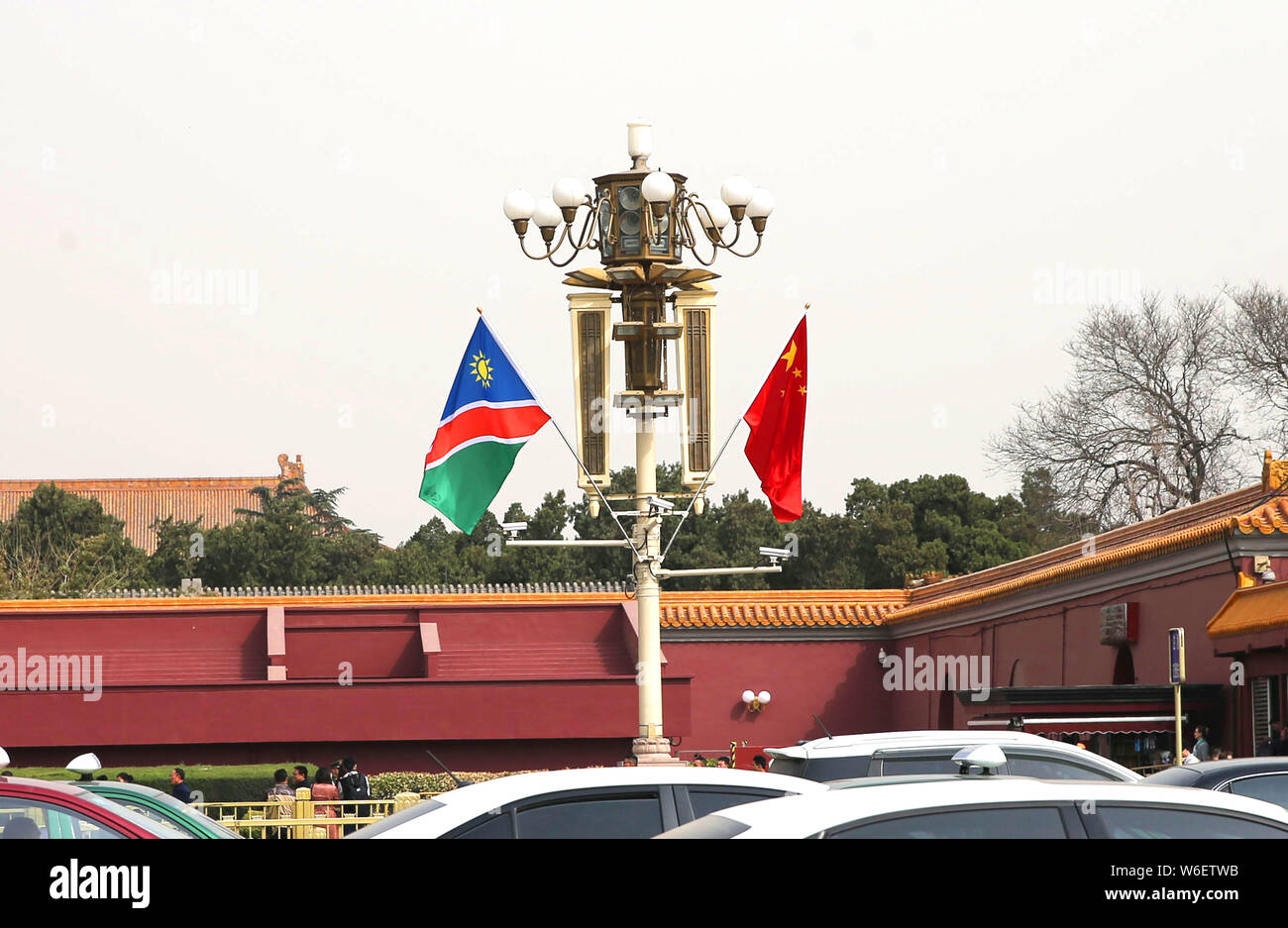 Chinese and Namibian national flags flutter on a lamppost in front of ...