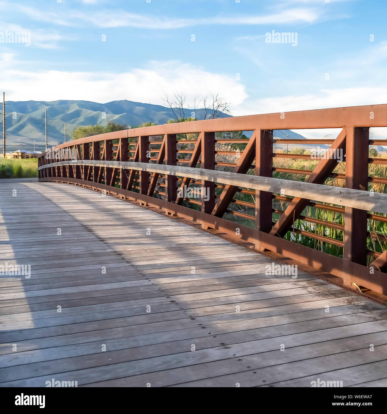 Square frame Bridge over a lake with view of mountain and valley under ...