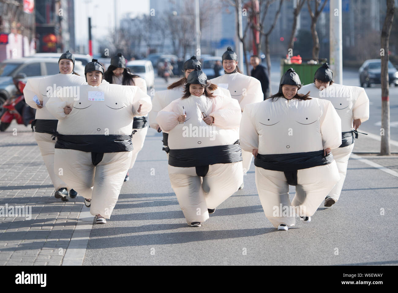 Chinese women dressed in inflatable sumo-wrestler costumes take part in ...