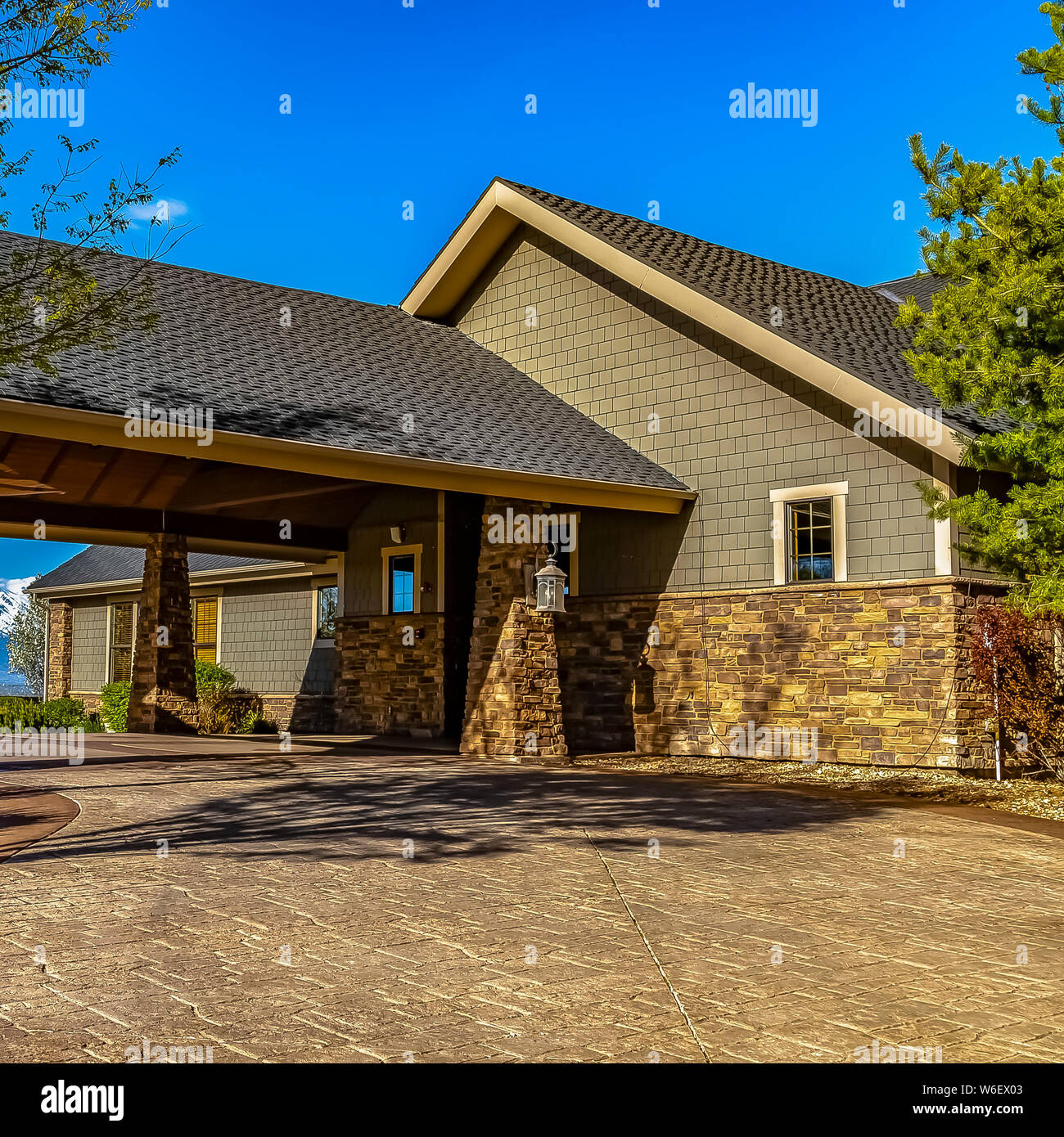 Square Exterior of a home with view of the paved driveway and pavilion ...