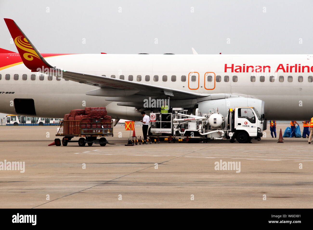 A jet plane of Hainan Airlines of HNA Group is refueled at the Wuhan ...