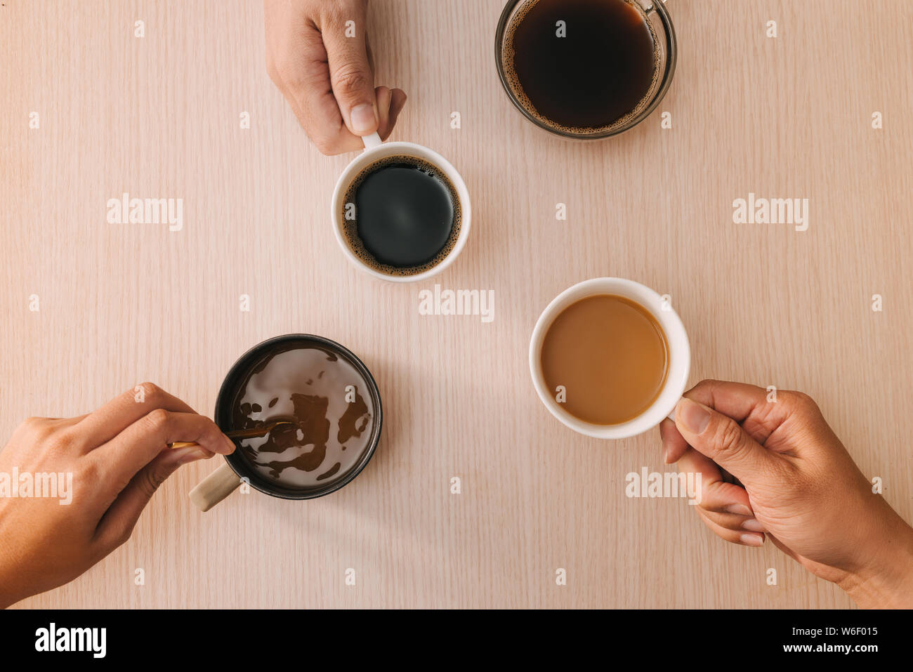 Hands holding cups hi-res stock photography and images - Alamy