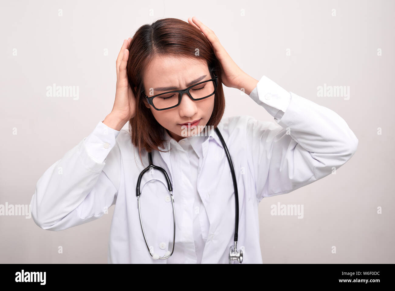 medical doctor woman with stethoscope problem, hold hand head on white ...