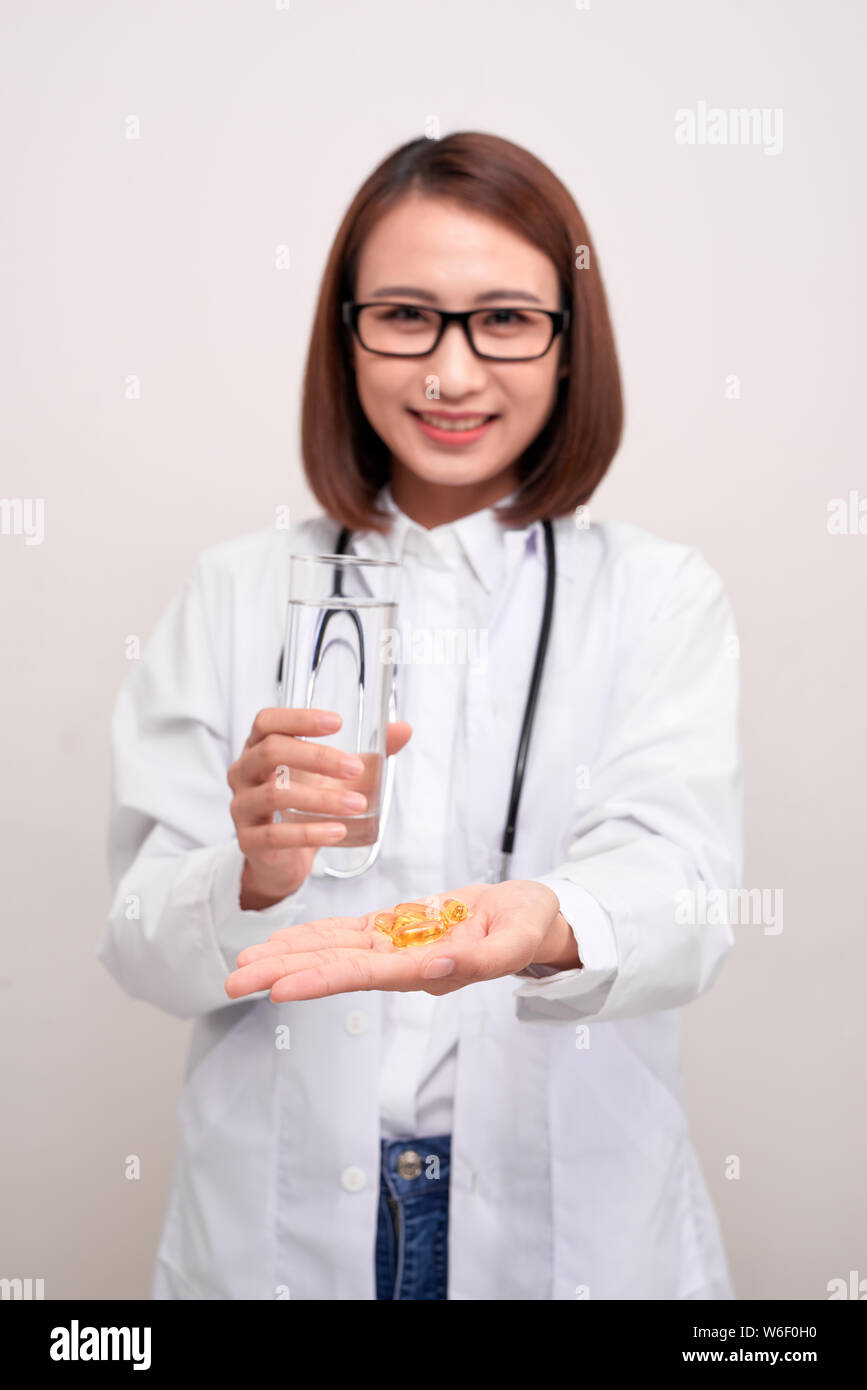 Doctor woman holding water and medicine on white background Stock Photo ...