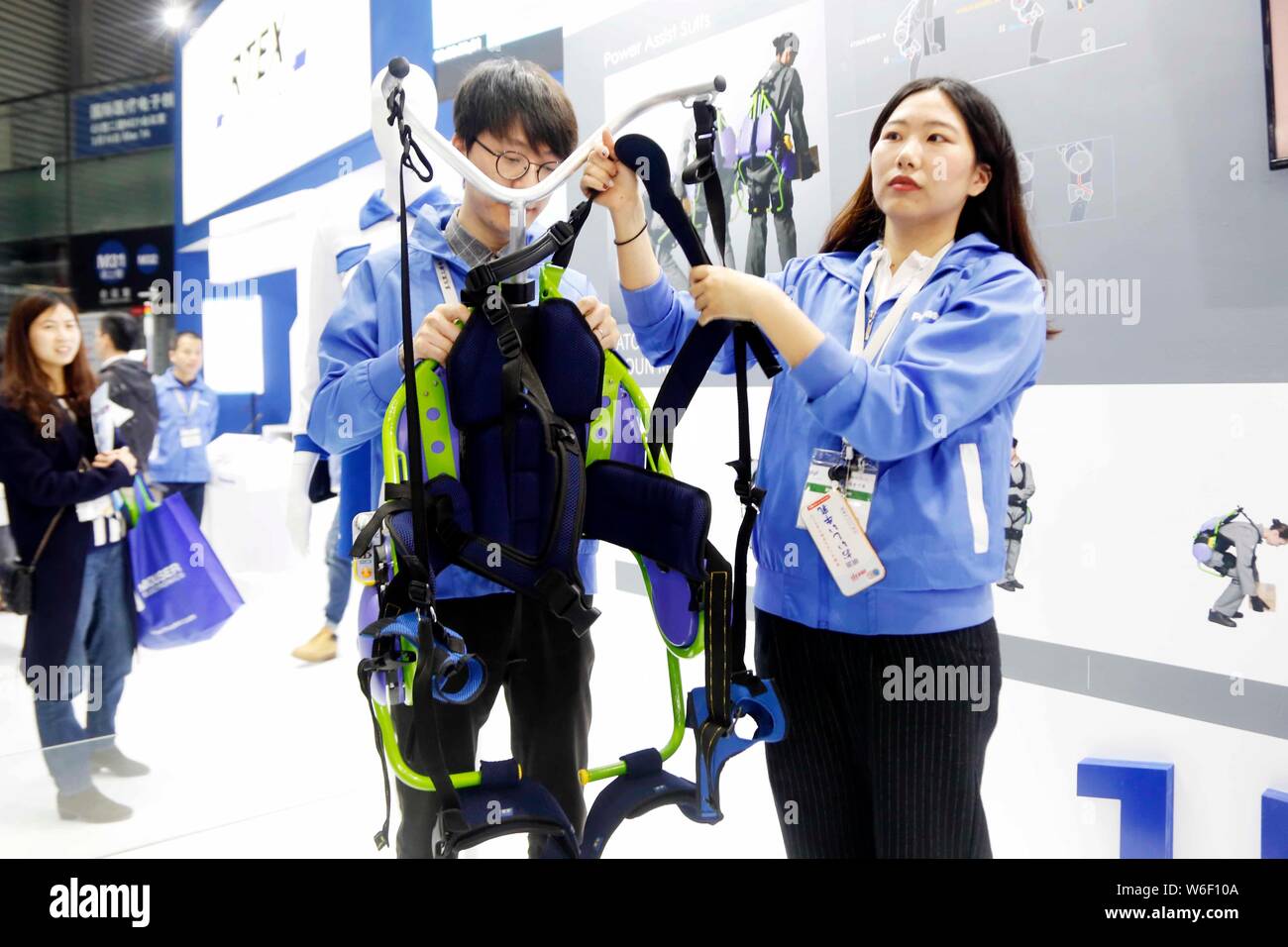 Exhibitors show a robotic exoskeleton during the Electronica China 2018 ...
