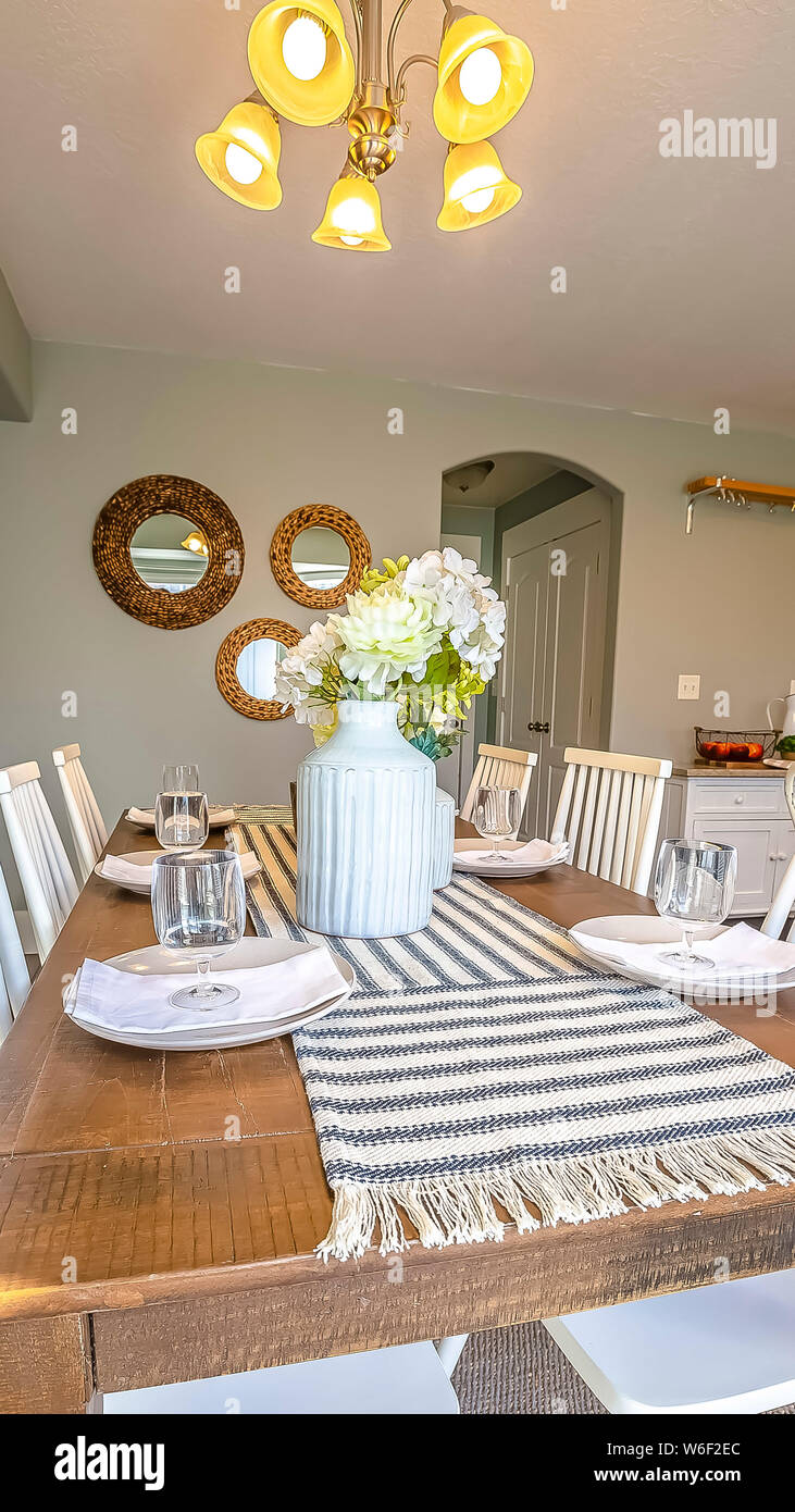 Vertical frame Dining room interior of a home with brown wooden table ...