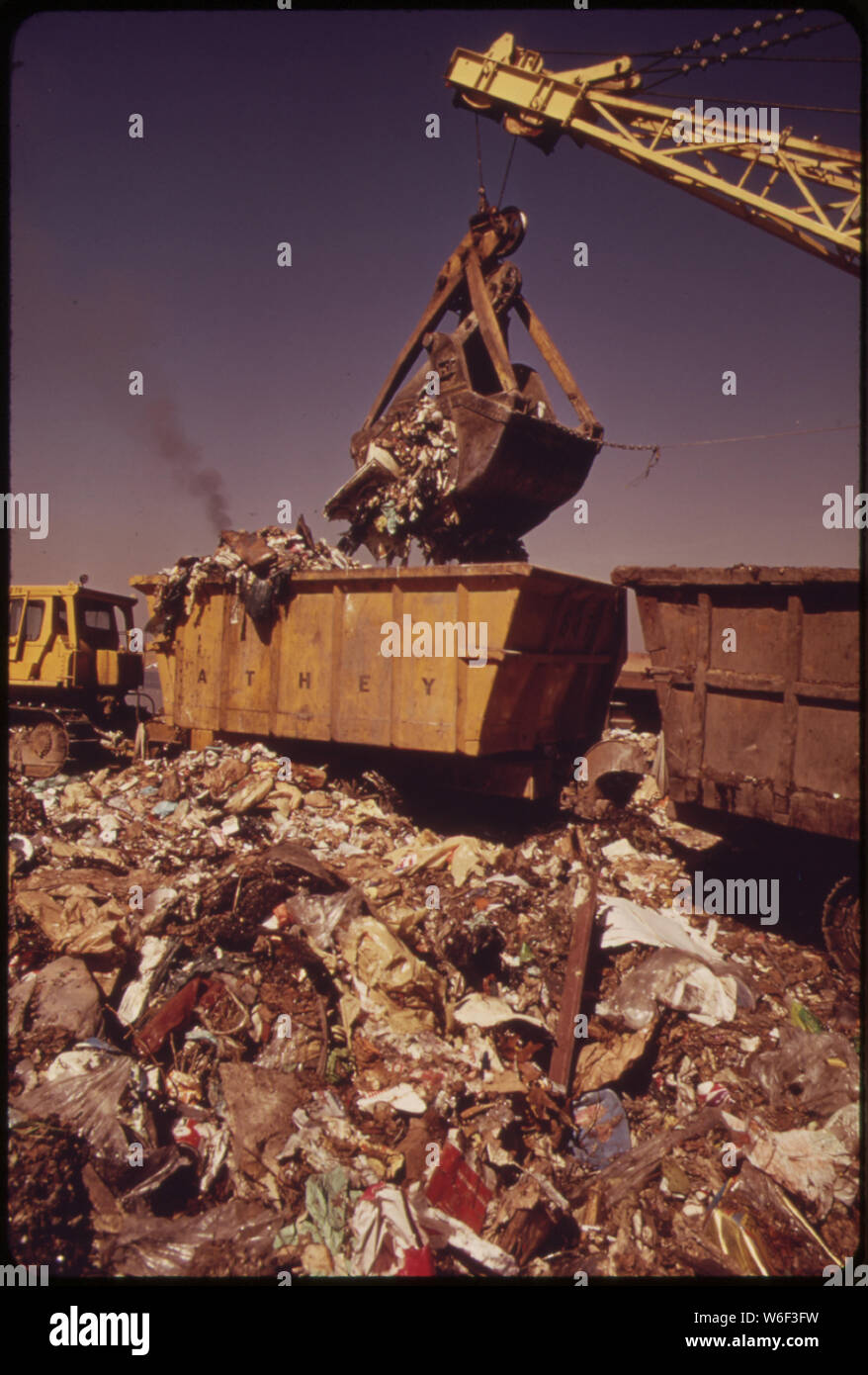 AT STATEN ISLAND LANDFILL STEAM SHOVEL LOADS CARTS WITH GARBAGE BROUGHT ...