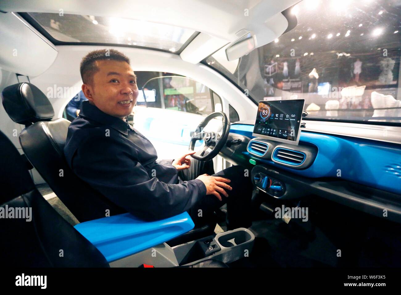 A visitor tries out a 3D-printed LSEV electric car of Italy-based X ...