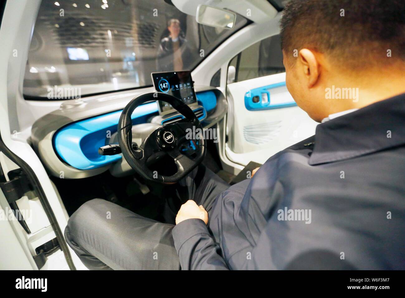 A visitor tries out a 3D-printed LSEV electric car of Italy-based X ...