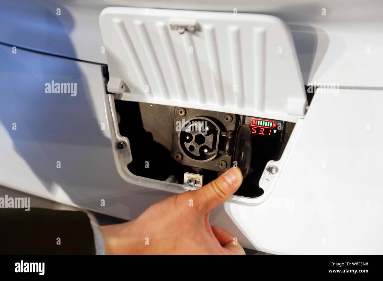 A visitor shows the socket of a 3D-printed LSEV electric car of Italy ...