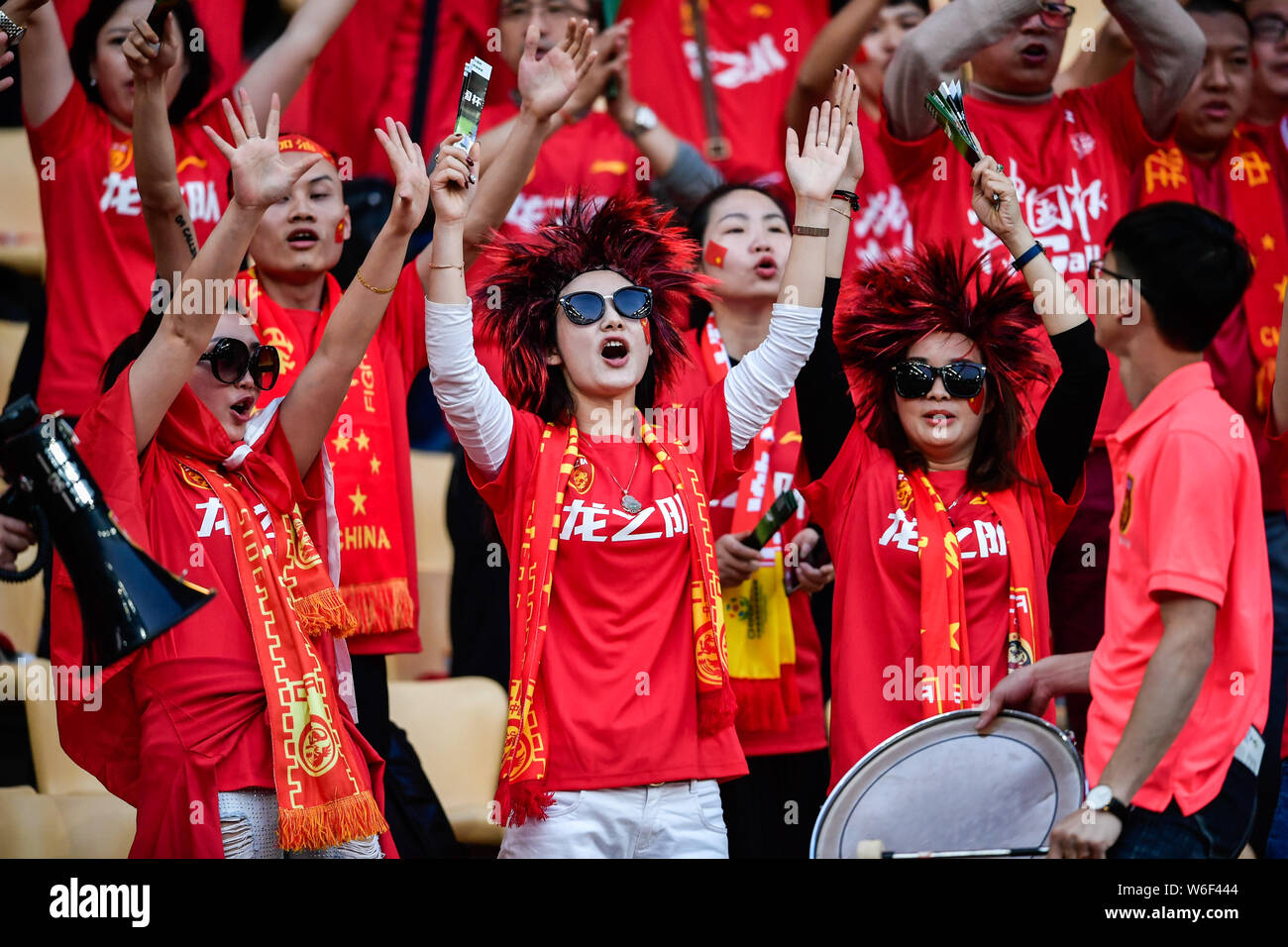 Chinese fans shout slogans to show their support for Chinese national ...