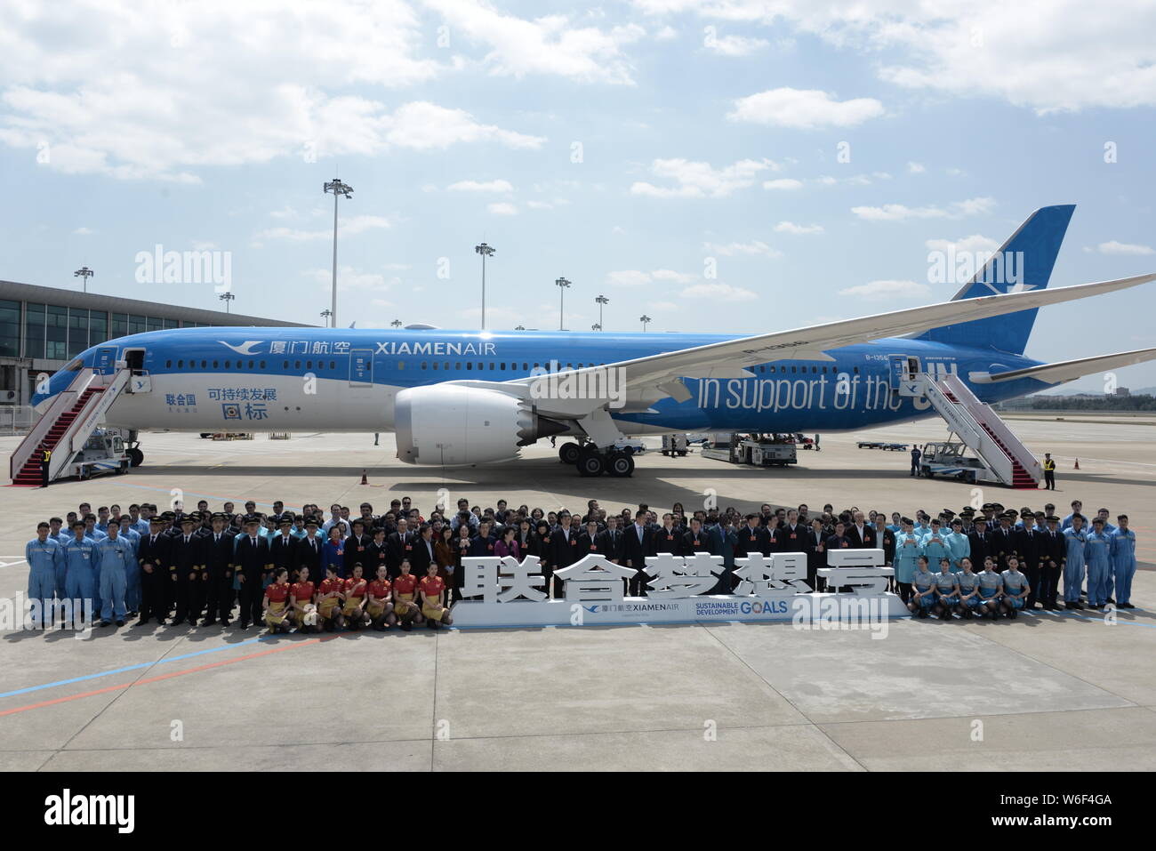 Crew members of China's Xiamen Airlines poses for photos with the first ...