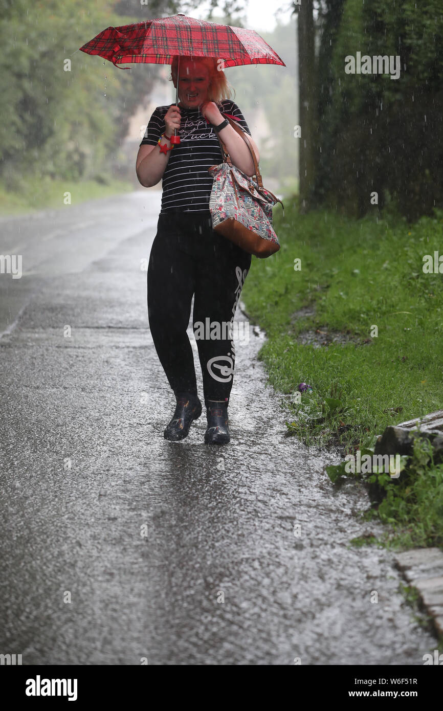 Woman walks through heavy rain hi-res stock photography and images - Alamy