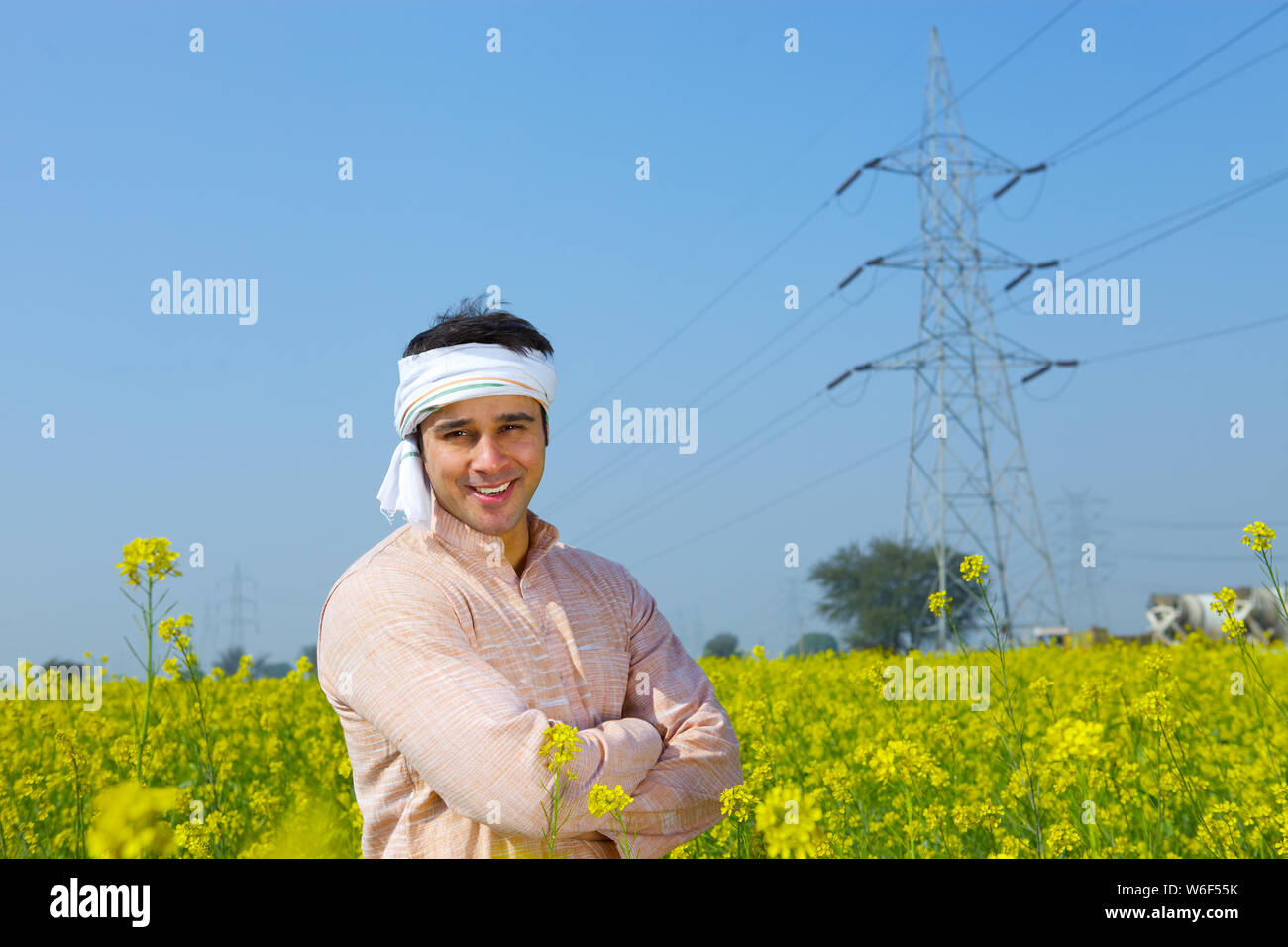 Farmer standing in a mustard crop field Stock Photo - Alamy