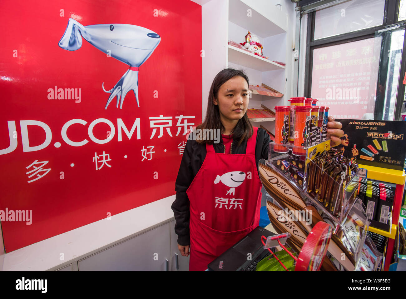 --FILE--A Chinese employee is pictured at a JD Convenience Store in ...