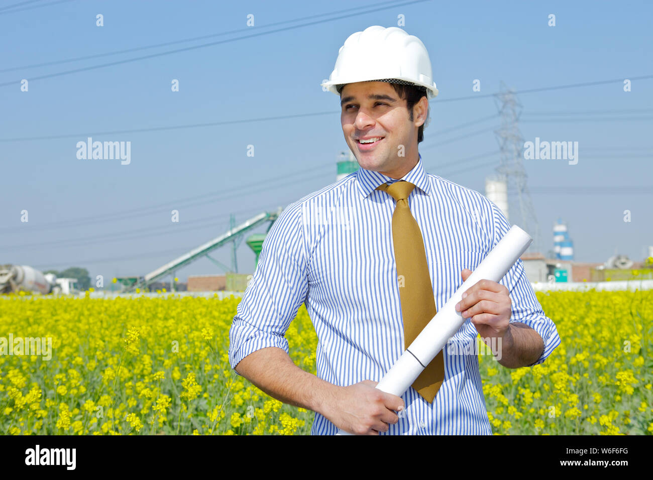 Architect holding blueprint at construction site Stock Photo - Alamy