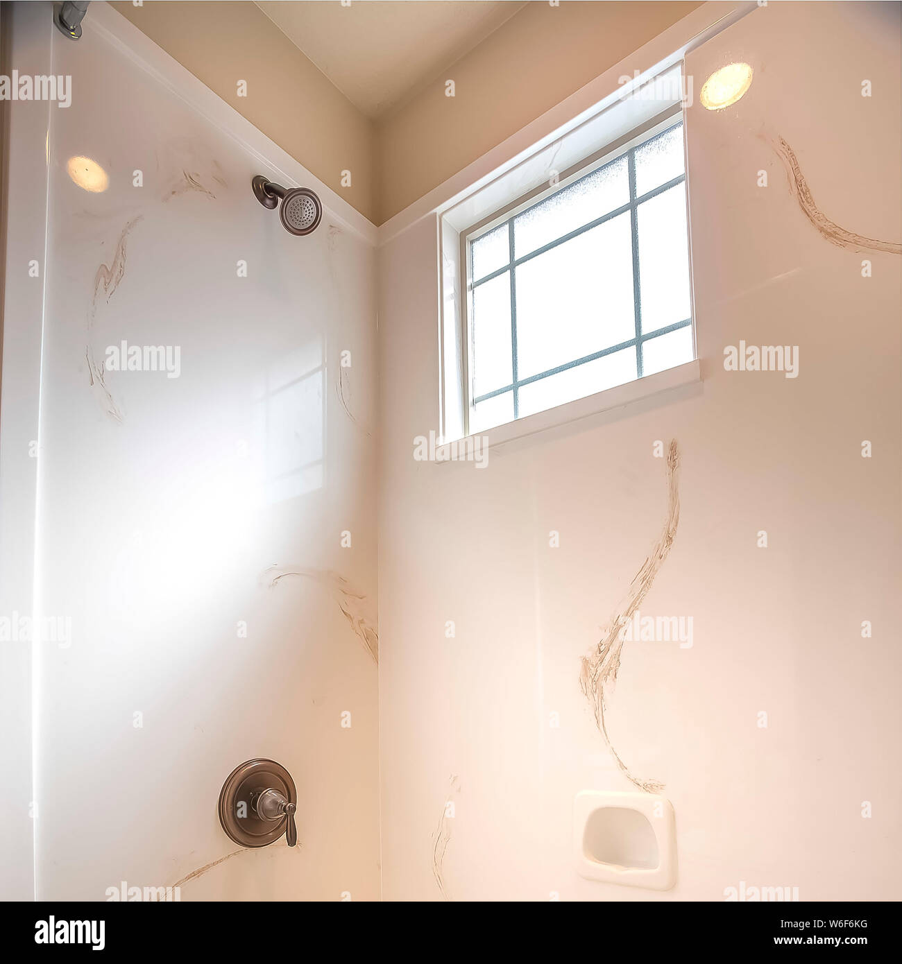 Square frame Shiny bathtub and shower inside the bathroom of a home ...